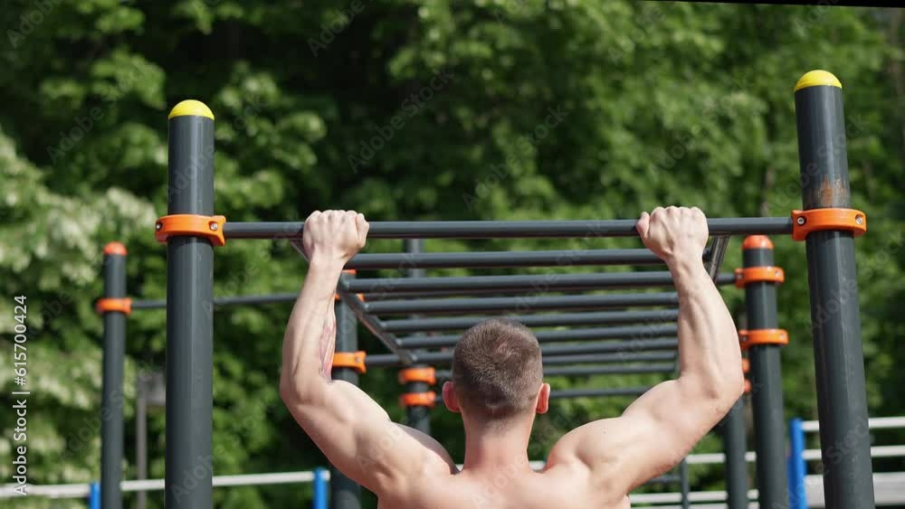 Back View Slow Motion Of Topless Fit Athlete Doing Pull Ups On Horizontal Ladder During Workout
