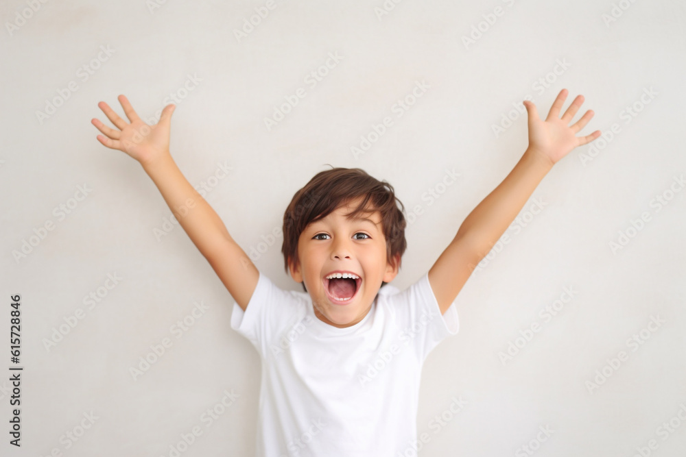 Happy little kid boy in white t-shirt celebrating with raised arms ...