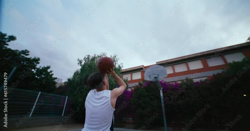 Basketball player shoot ball into hoop and keep focus on rim. Cinematic ...