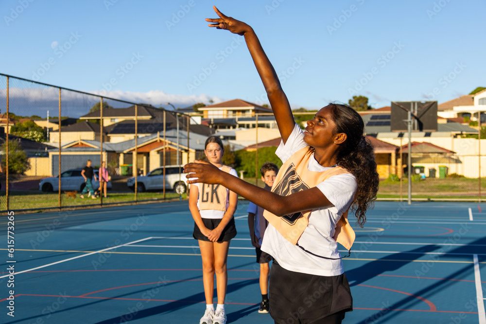 aboriginal girl shooting goal in netball team Stock Photo | Adobe Stock