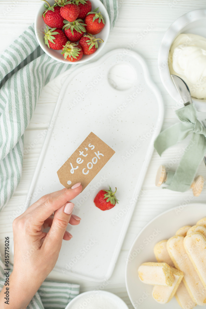 The process of making a dessert of Savoyard cookies, strawberries and ...