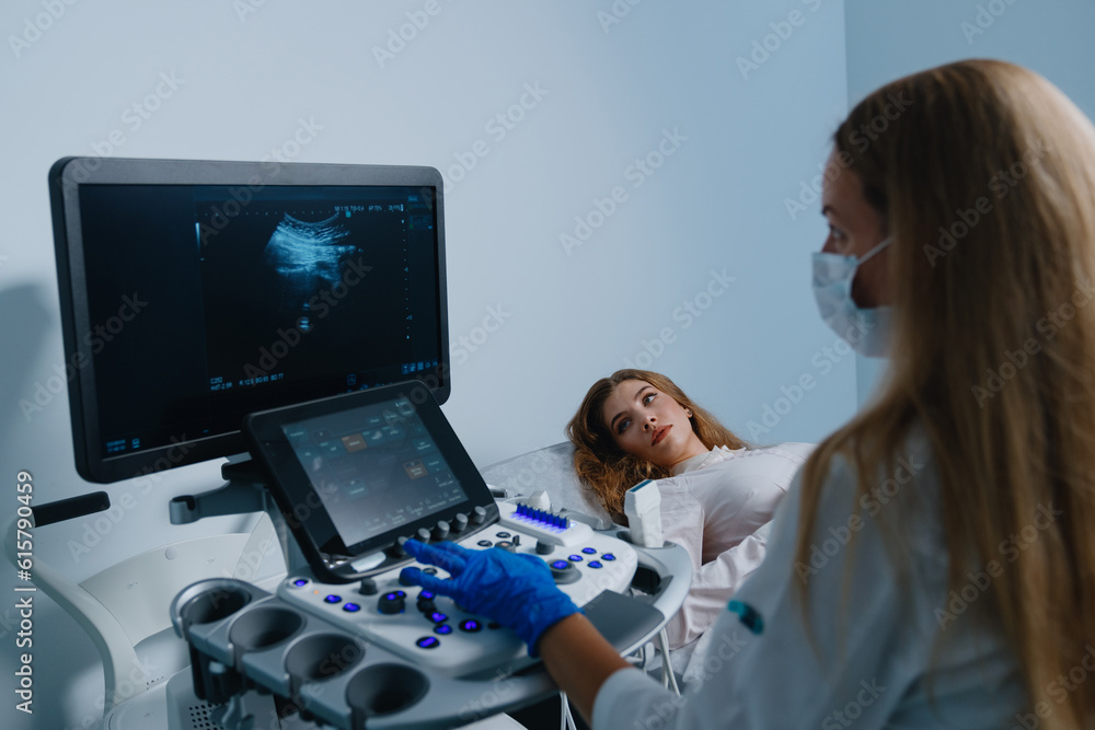 Check-up of health in the hospital. The doctor examines a young female ...