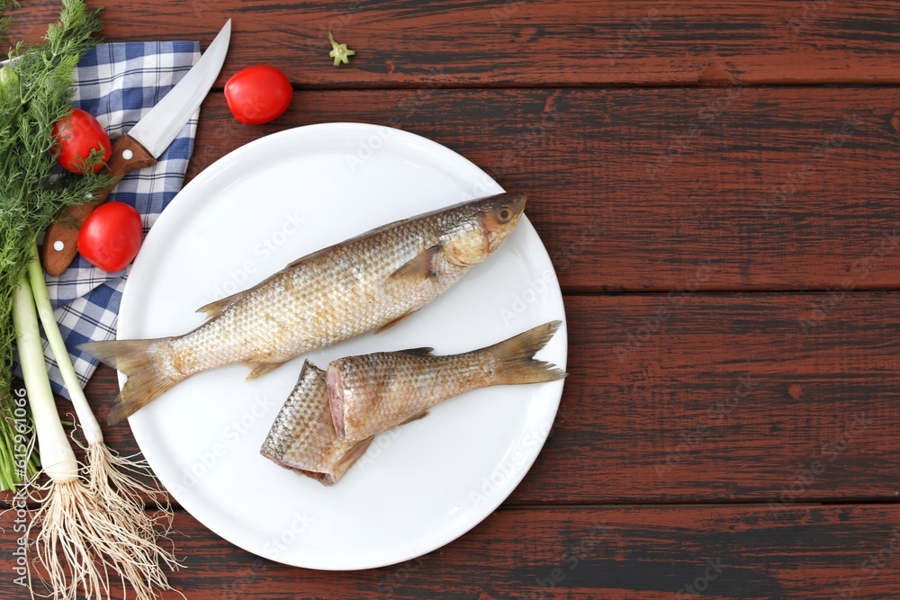 Salted fish on the table, mullet, wooden dark background, traditional ...