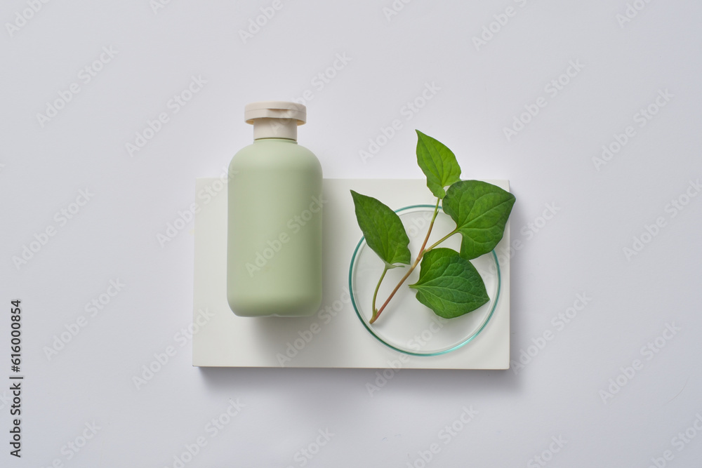 Rectangle podium with a pastel cosmetic bottle and a petri dish of fish ...