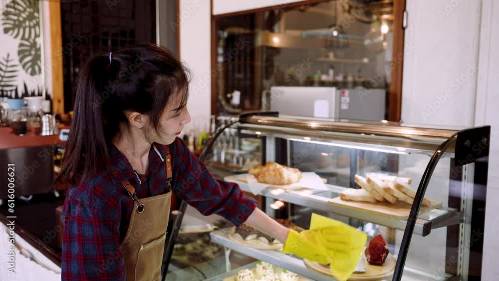 Asian woman works in cafe bakery, woman was wearing apron with rubber ...