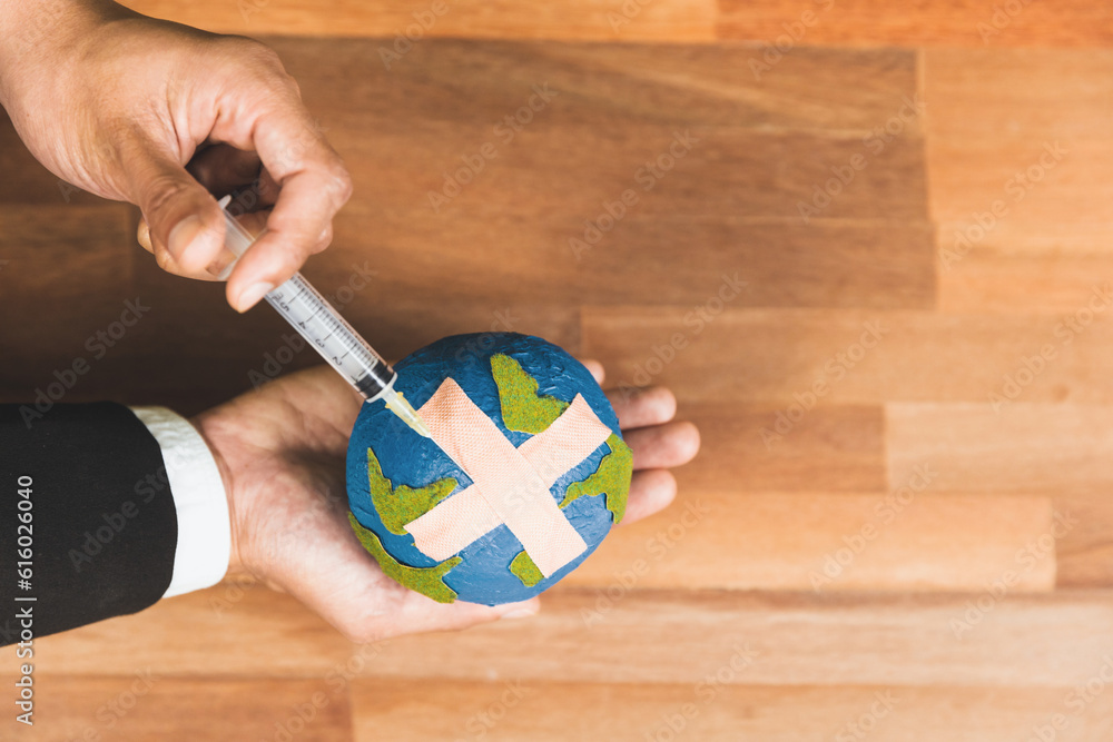 Fotka „Top view businessman holds and inject medicine to paper earth as ...