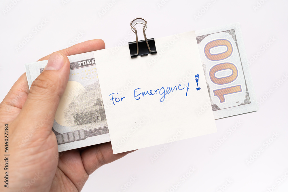 Dollars cash money and paper note with text written FOR EMERGENCY ...