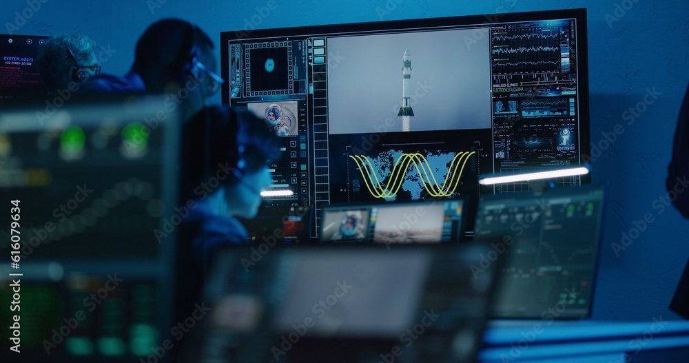 Flight control operators monitor space mission on computers in command ...