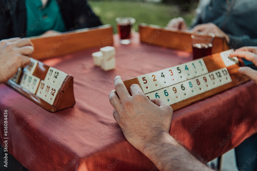 A group of men drink traditional Turkish tea and play a Turkish game ...