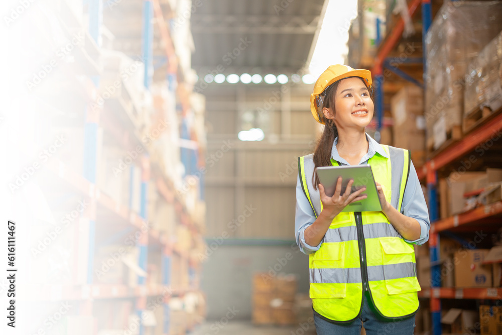 Warehouse workers using a digital tablet while recording inventory ...