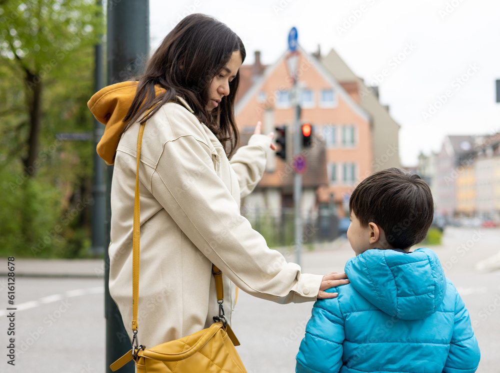 mom showing to kid child boy that is not allowed to pass street on red ...