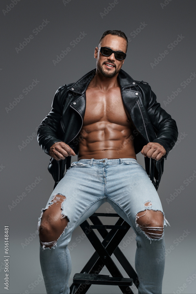 Handsome male model with muscular shirtless torso flashes a wide smile ...