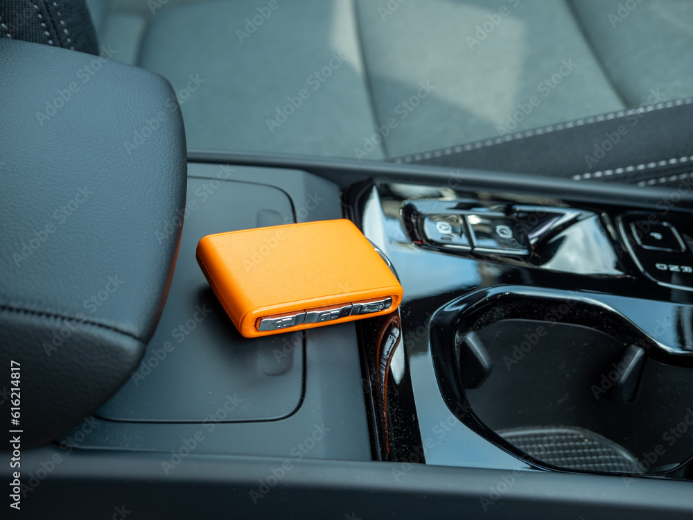 Car ignition key on the armrest in the interior of a modern car. Forgot ...