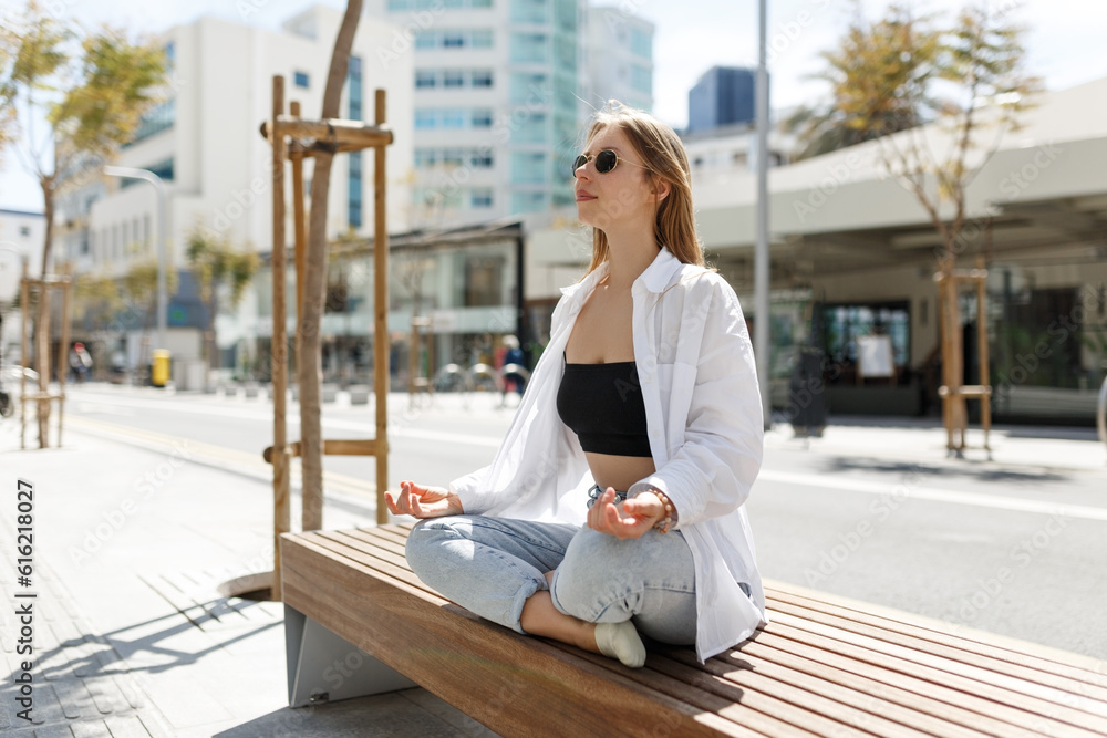 Beautiful young adult woman meditating sitting crossed leg lotus pose ...