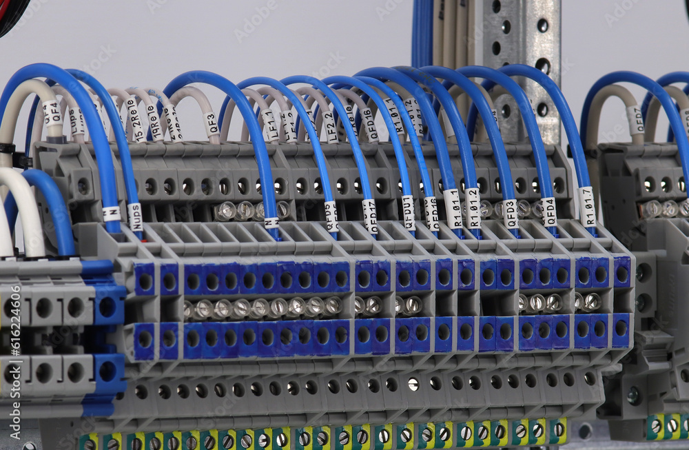 Electrical terminals with connected mounting wires are installed in an ...