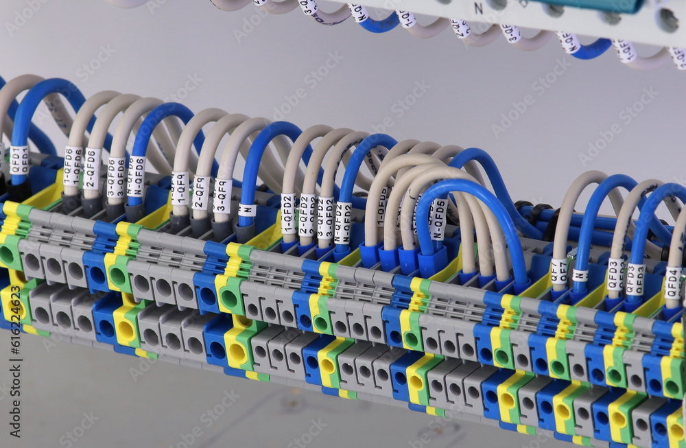 Electrical terminals with connected mounting wires are installed in an ...