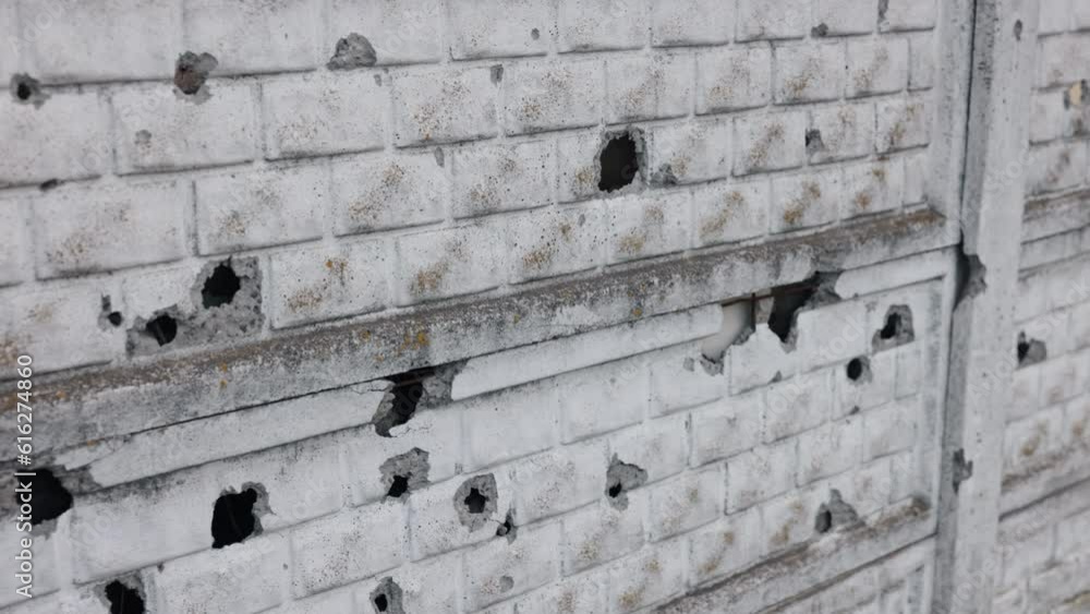 Bullet riddled, after shelling, pierced wall. Ukrainian war has ...