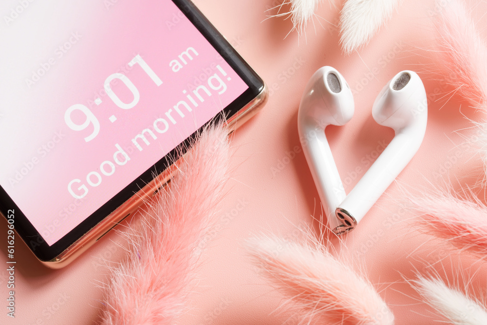 Smartphone with an indication of the morning time and good morning wish ...