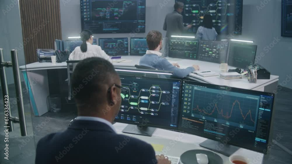 African American big data scientist works at computer in monitoring ...