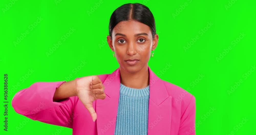 Thumbs down, finger and face of indian woman on green screen, studio ...