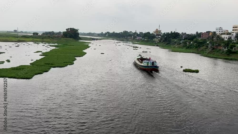 Medium transportation trawler going through a beautiful river in a ...
