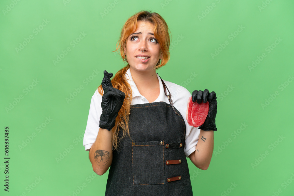 Butcher caucasian woman wearing an apron and serving fresh cut meat ...