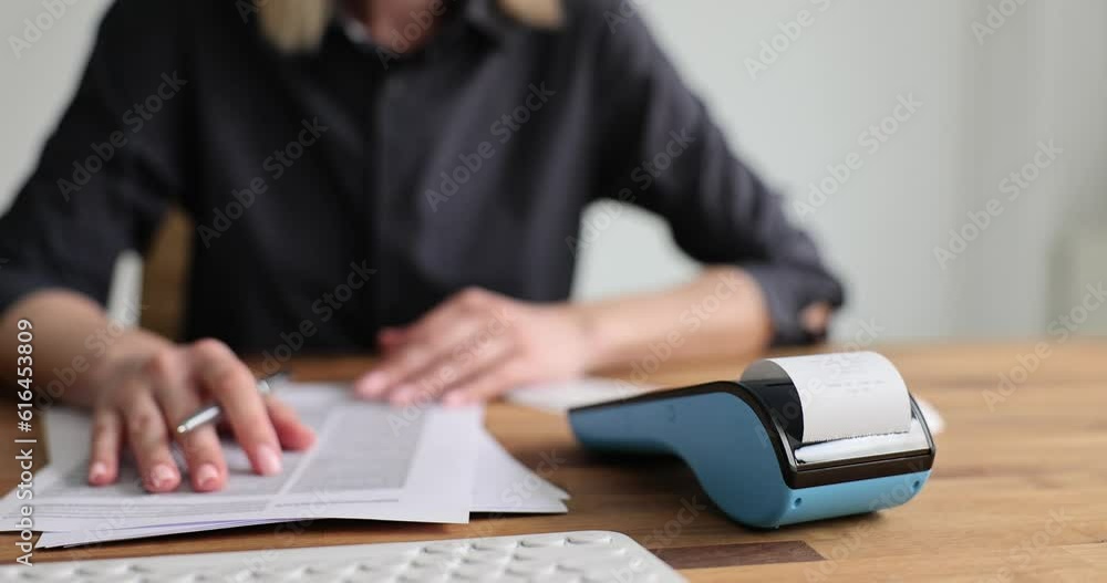Administrator or bank employee with documents tears off receipt for ...