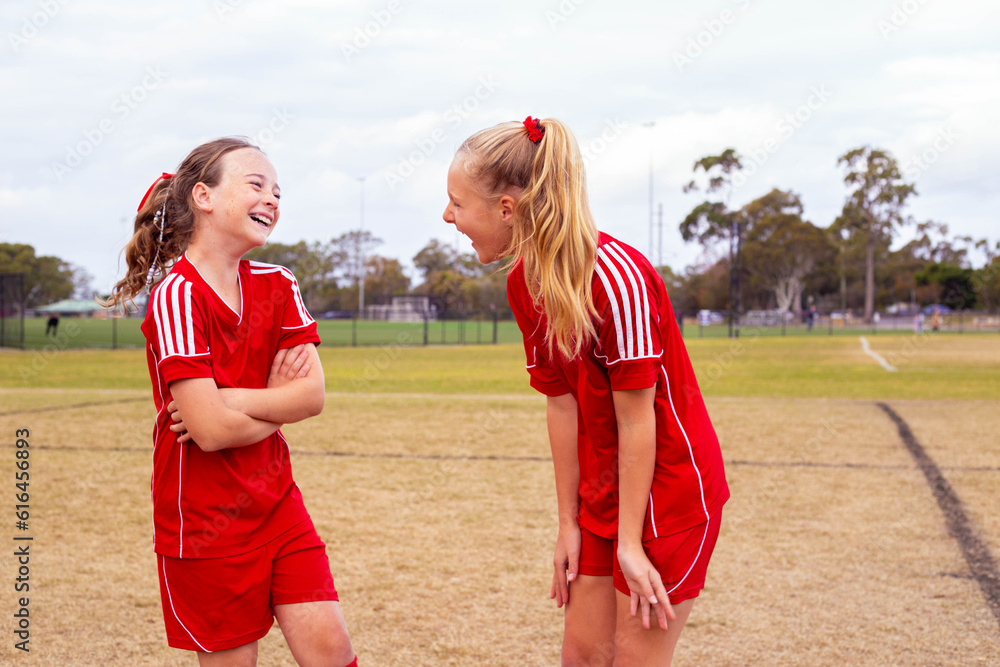 Tween girls from the same football team laughing together Stock Photo ...