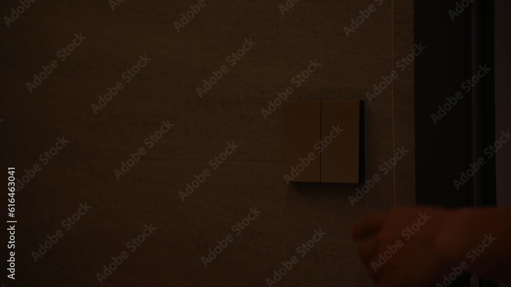 Close up male hand control the light to save electrical energy. Finger ...