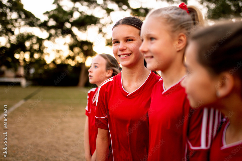 A tween girls football team training together at a sports oval Stock ...