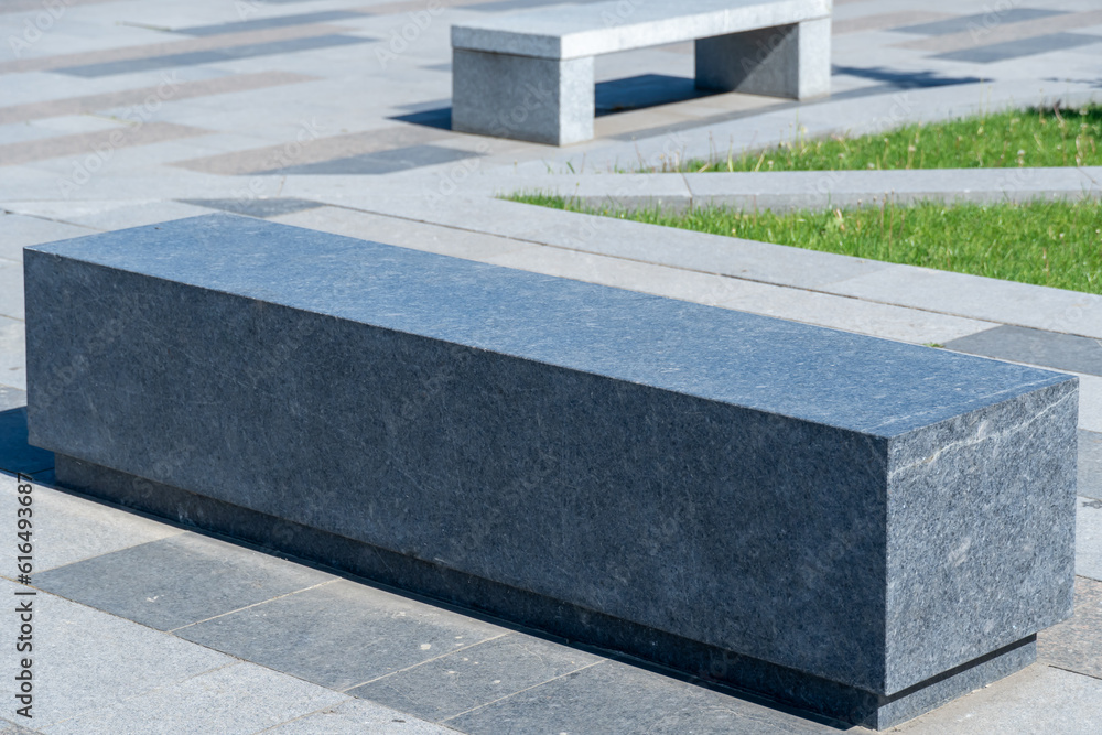 Comfortable stone bench in city park. Design of gray stationary seat ...