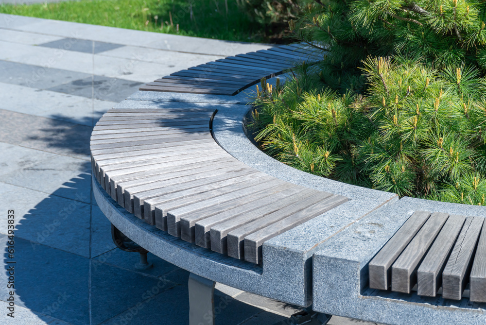 Comfortable in stone and wooden material bench in city park. Design of ...