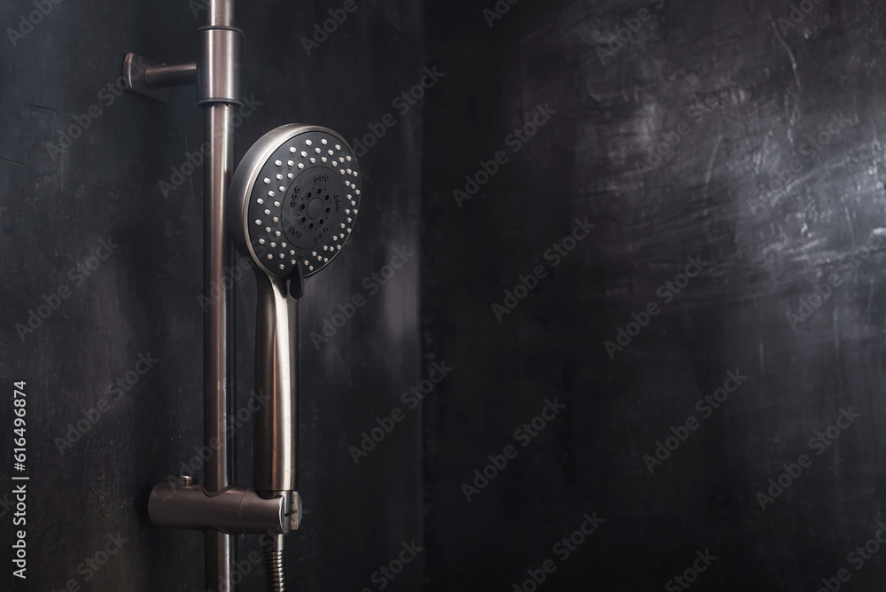 Shower head in bathroom with dark black background, simple and modern ...