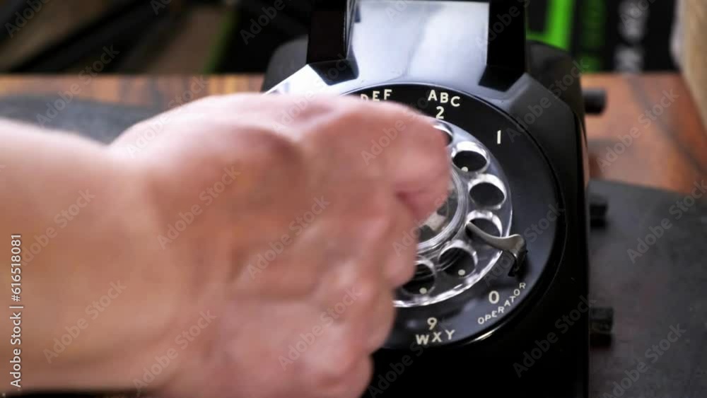 Nostalgic Connection: Close-Up of a Man Dialing a Classic Old Rotary ...