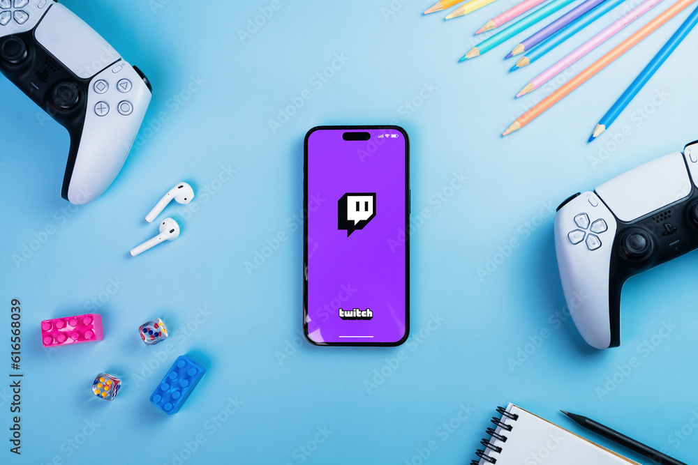 Twitch app on the smartphone iPhone 14 Pro screen on blue table with ...