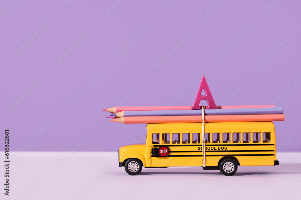 School bus with bunch of pastel pencils and A letter on top with lilac ...