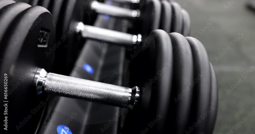 Sports dumbbells in gym concept. Sports equipment for strength ...