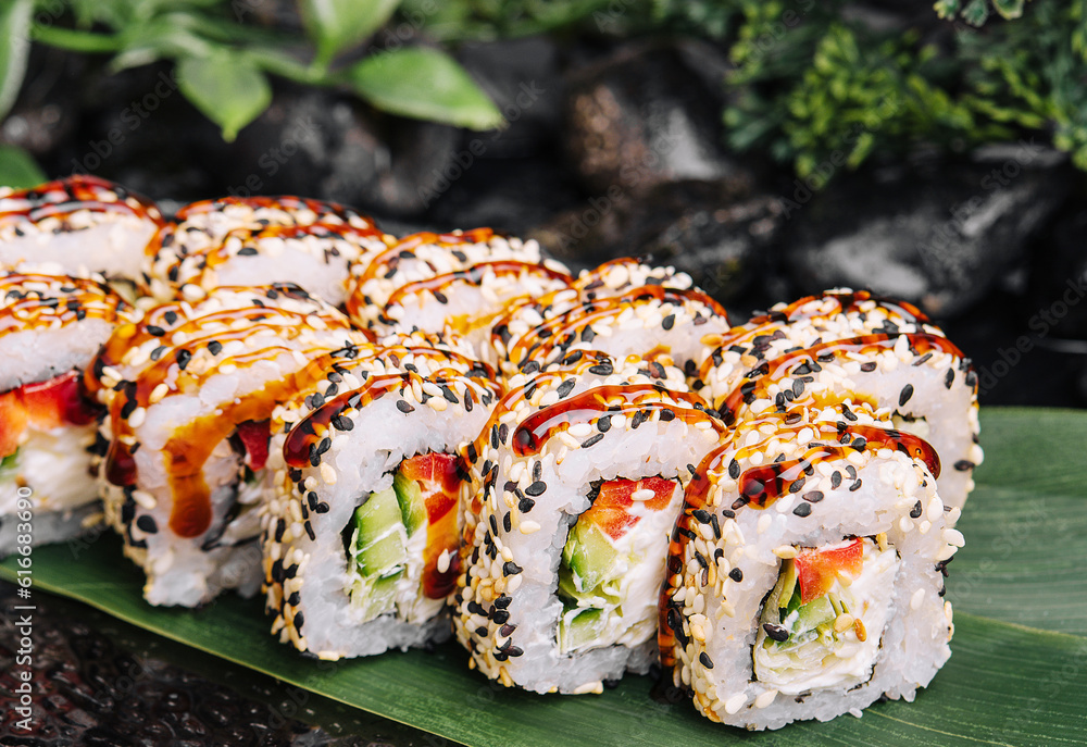 Sushi rolls maki in rows with salmon, cheese sauce and cucumber Stock ...