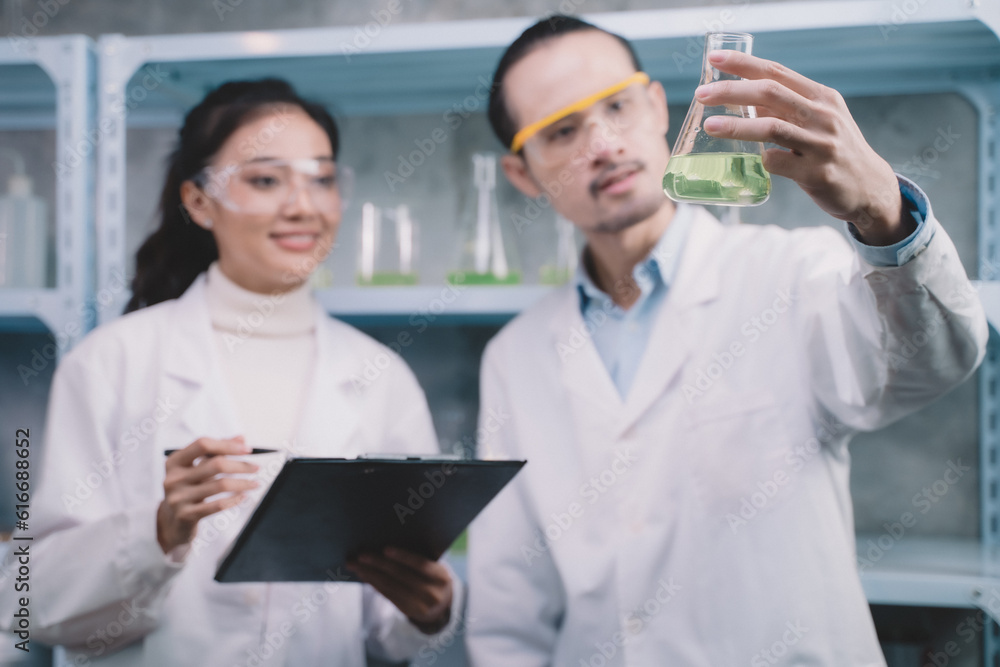 2 Researcher chamical are seeing the samples in glasses and smile in ...