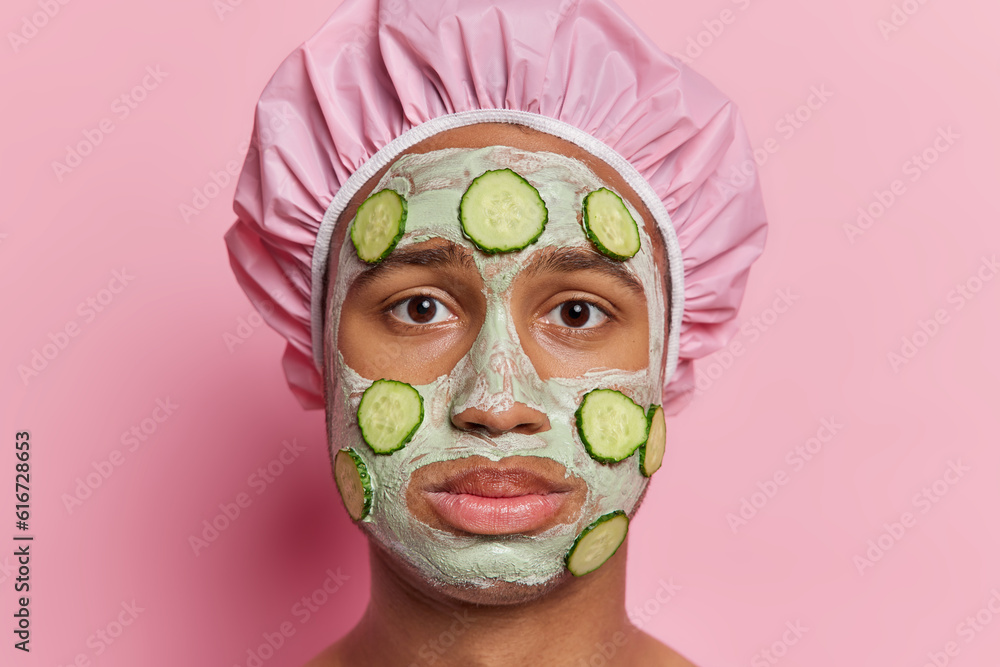Headshot of young man immerses himself in pampering procedures with ...