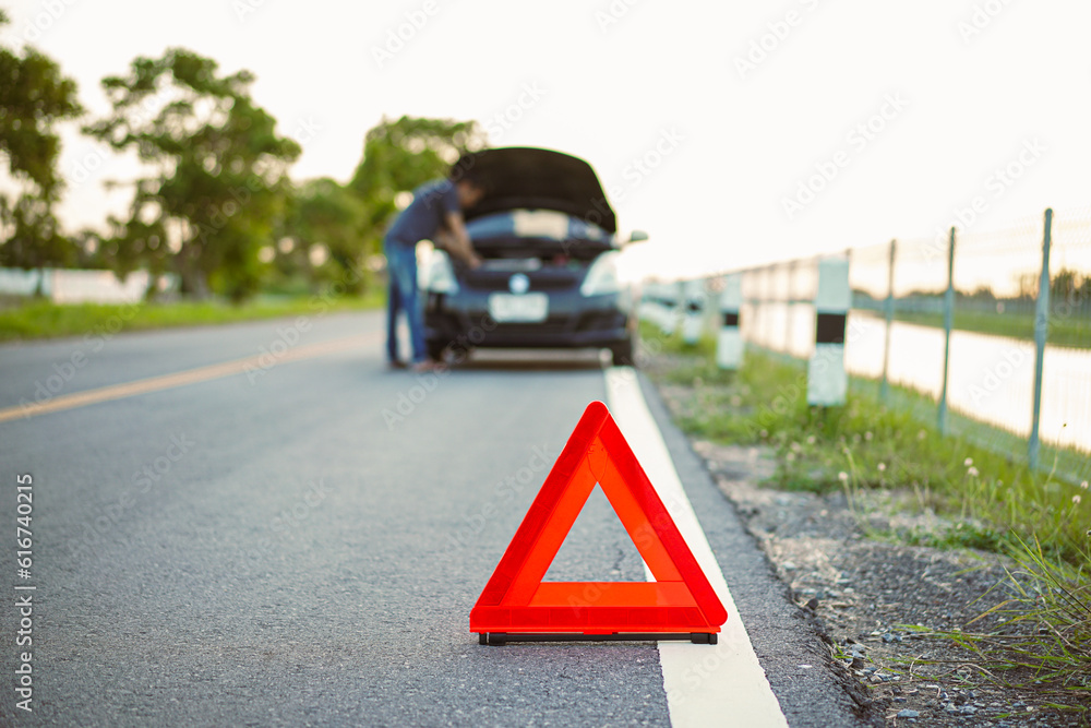 Red emergency stop sign with broken black car on the road. Red ...