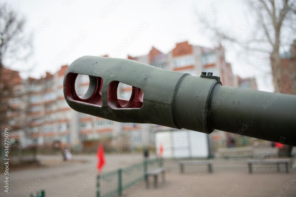 Muzzle brake of a gun at a military base in the city. Stock Photo ...