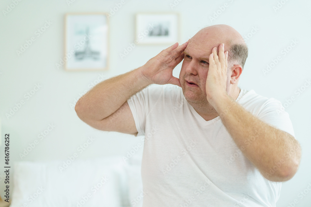 Portrait of unwell - unhappy caucasian white fat man wake up from bed ...