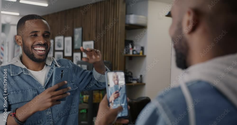 Joyful guy taking selfie with smartphone posing in front of barbershop ...