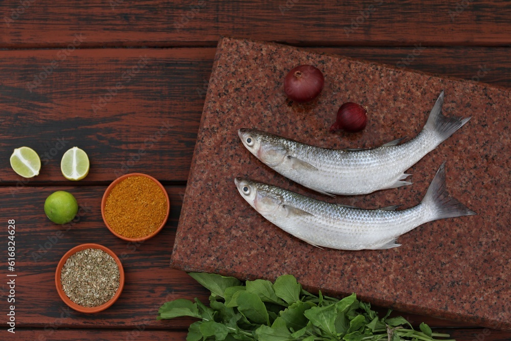 Sea fish mullet, Buri, Loban, on a wooden table, top view, background ...