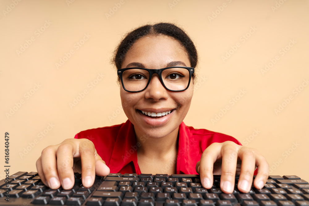 Smiling African American woman typing on keyboard shopping online with ...