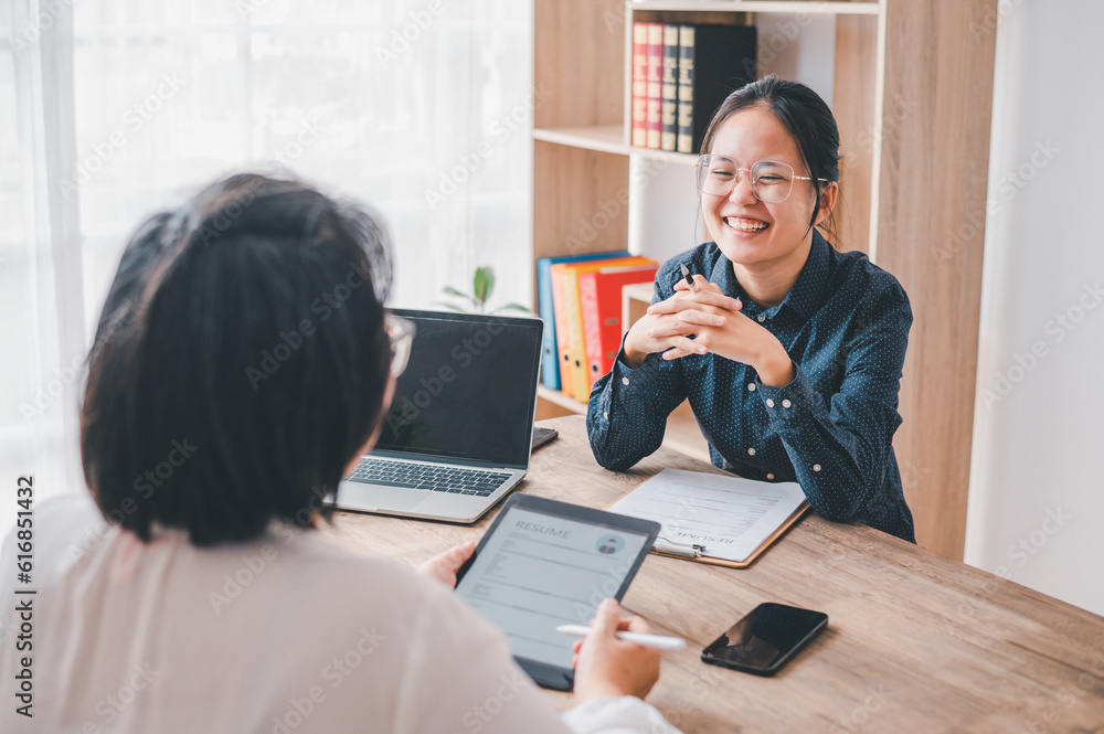 HR managers are interviewing job applicants who fill out their resume ...