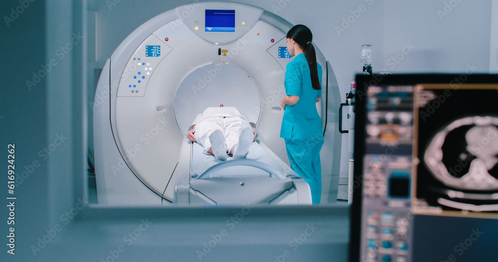 Nurse send patient to MRI capsule on moving table. Magnetic resonance ...
