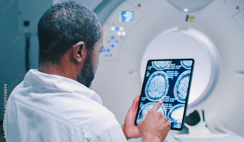 African American doctor examine scan attentively. Medical worker ...