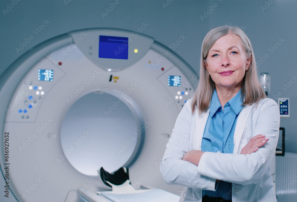 Portrait of female doctor at background of MRI capsule. Middle-aged ...